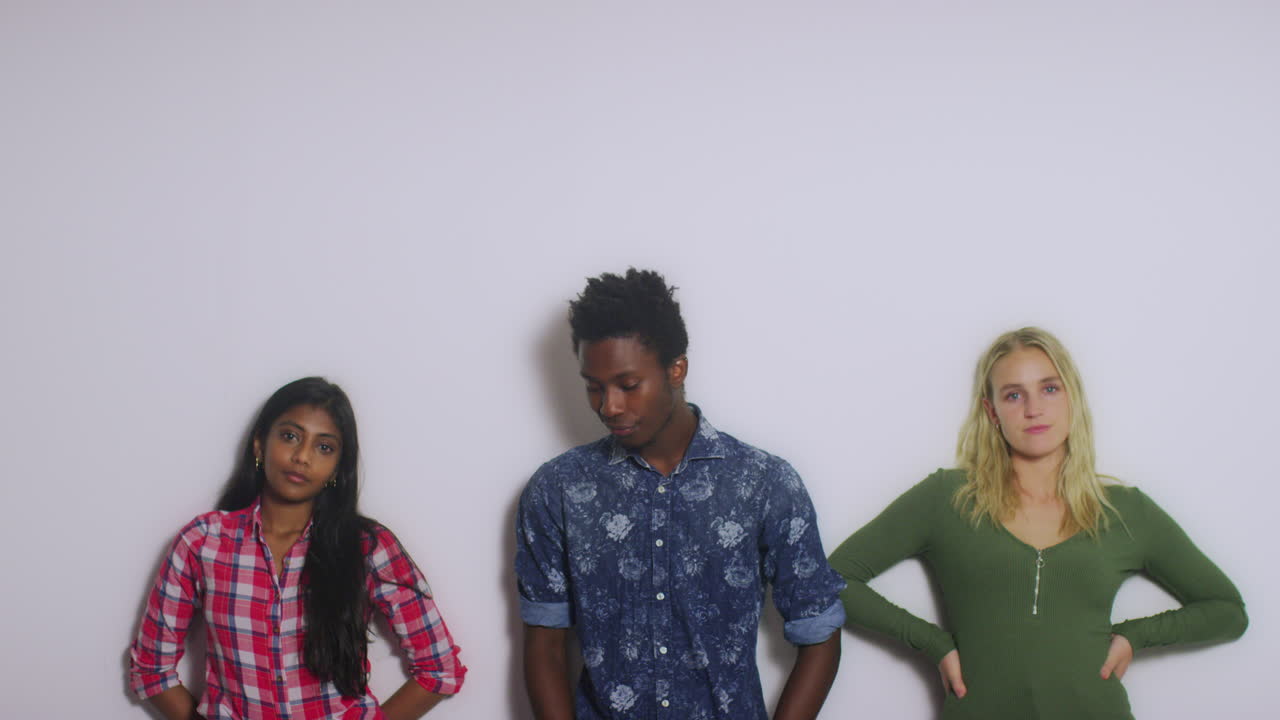 Free stock video - 3 young people leaning on wall copy space