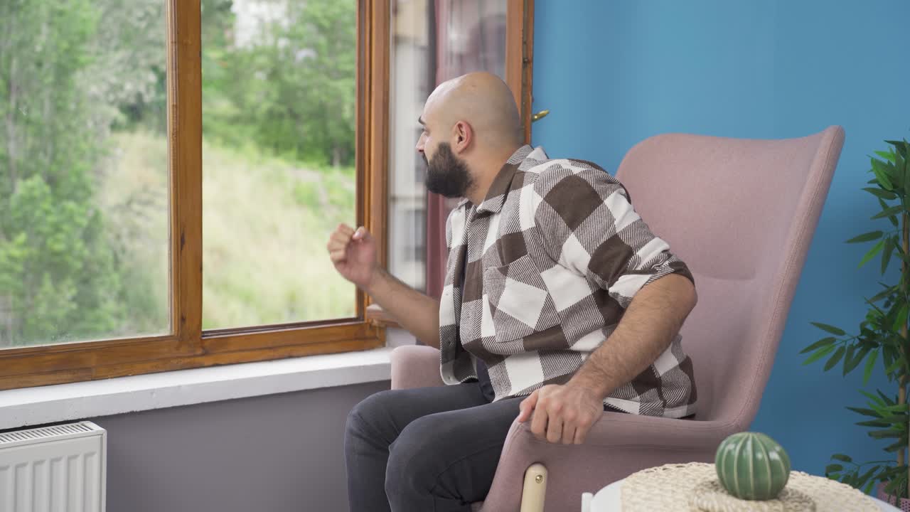 Premium stock video - The man shouting for help from the window.