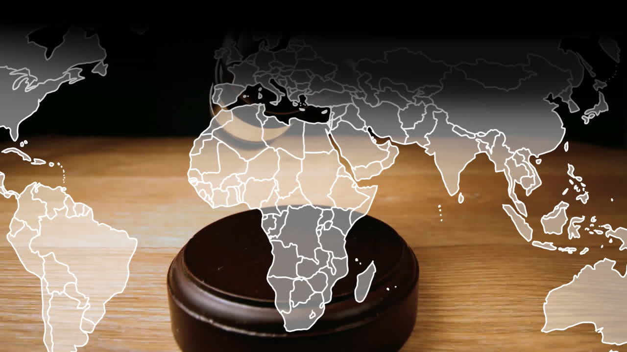 Premium stock video - Animation of world map over falling gavel