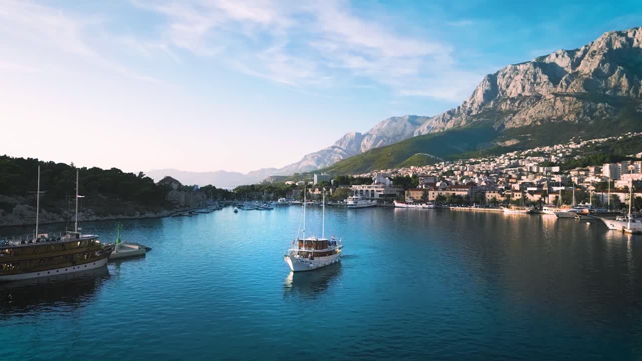 Zoom out shot of a majestic water body situated in valley amid the high ...