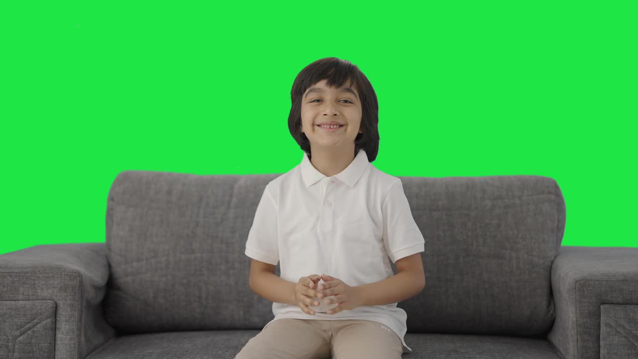 Premium stock video - Happy indian boy doing namaste green screen