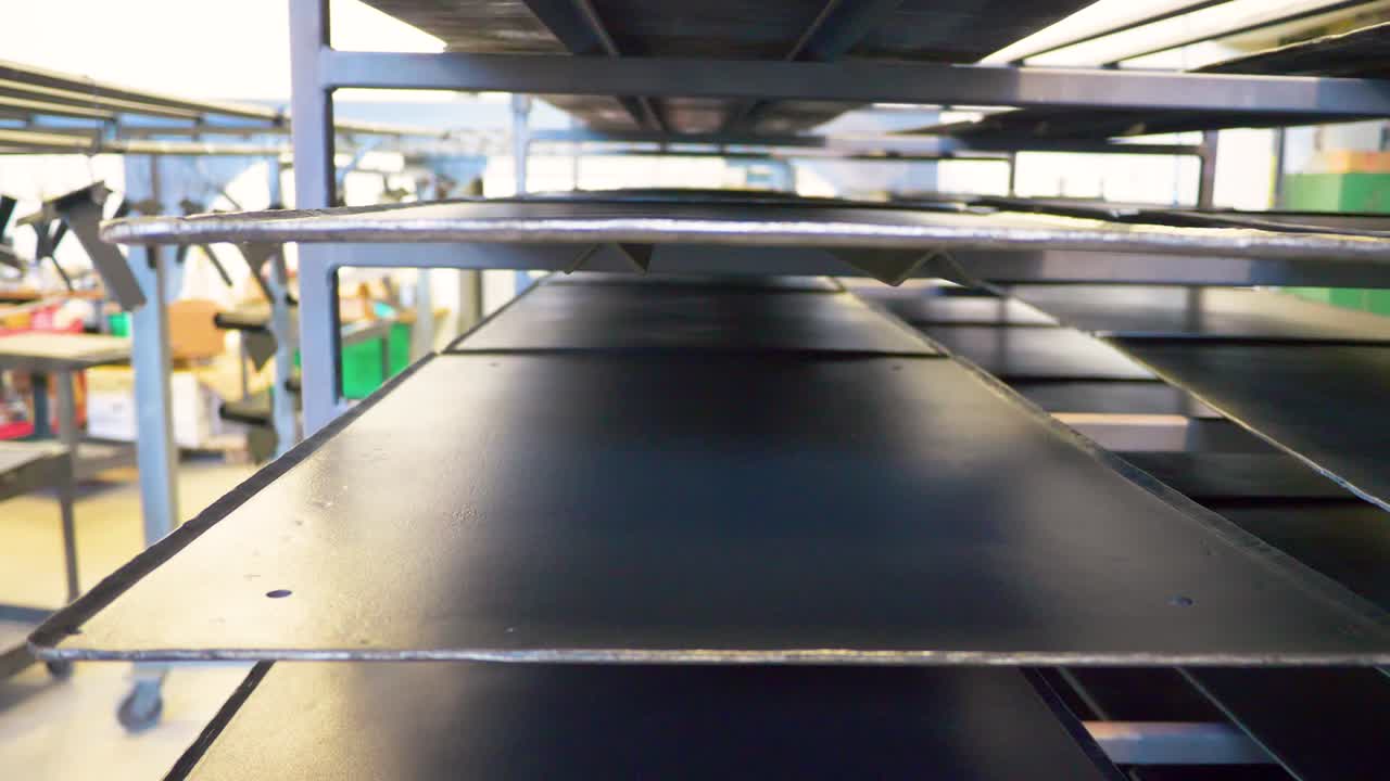 Premium stock video - Freshly coated food manufacturing trays drying