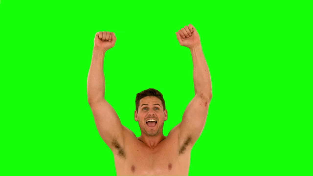 Premium stock video - Muscular man cheering and jumping