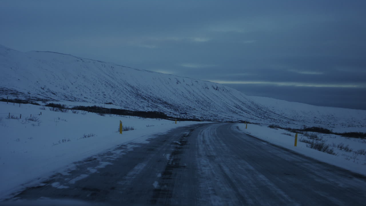 Snow covered arctic road in iceland winding through a frosty winter ...