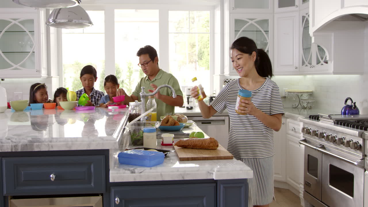 Premium stock video - Family having breakfast and making lunches shot ...