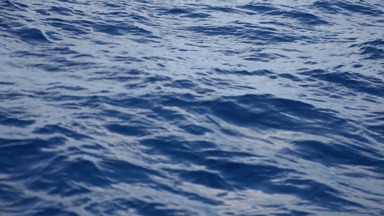 Sailing on wavy ocean, cinematic slow motion, blue water surface at ...