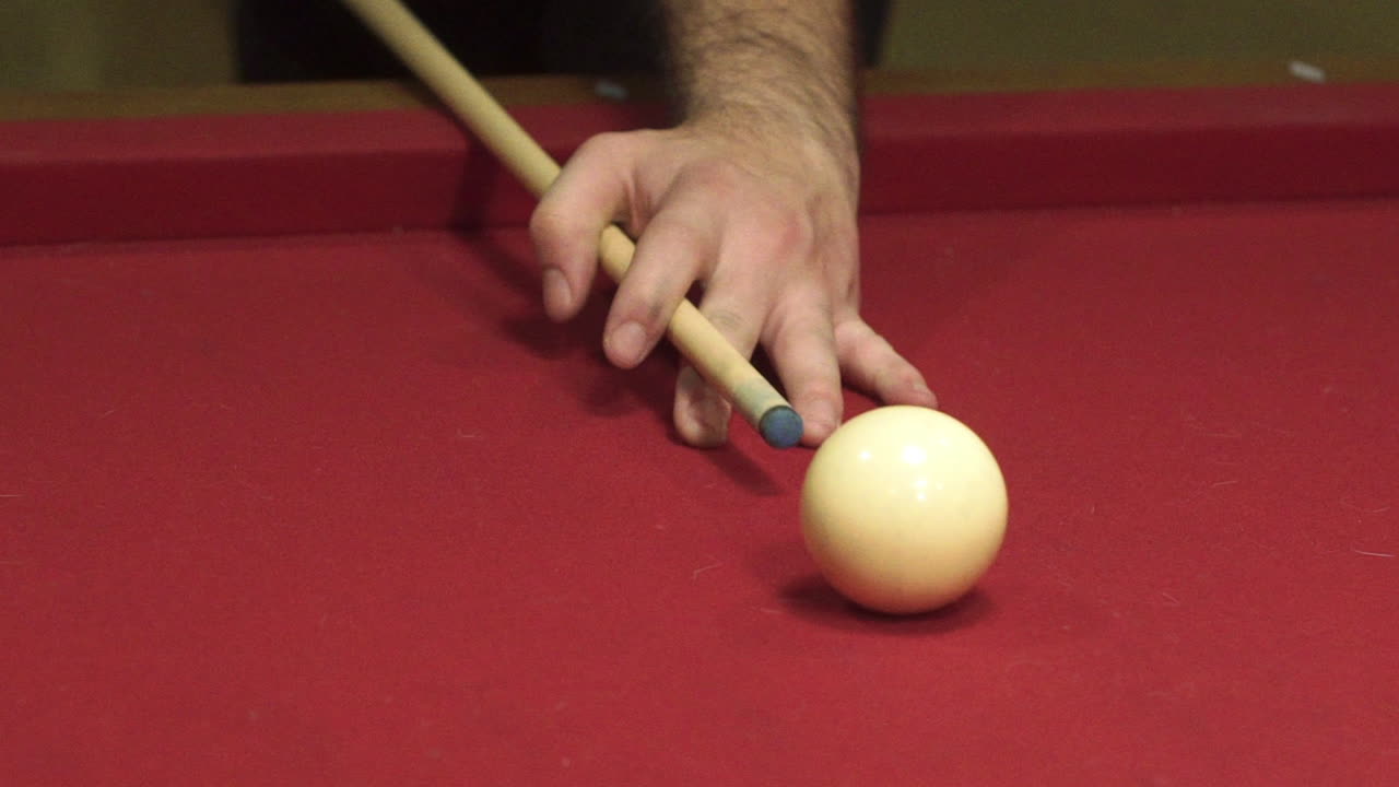 Premium stock video - Pool table billiards cue ball being struck