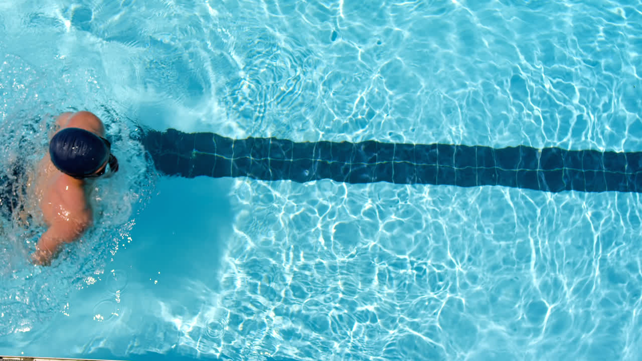 Premium stock video - Male swimmer swimming inside pool 4k