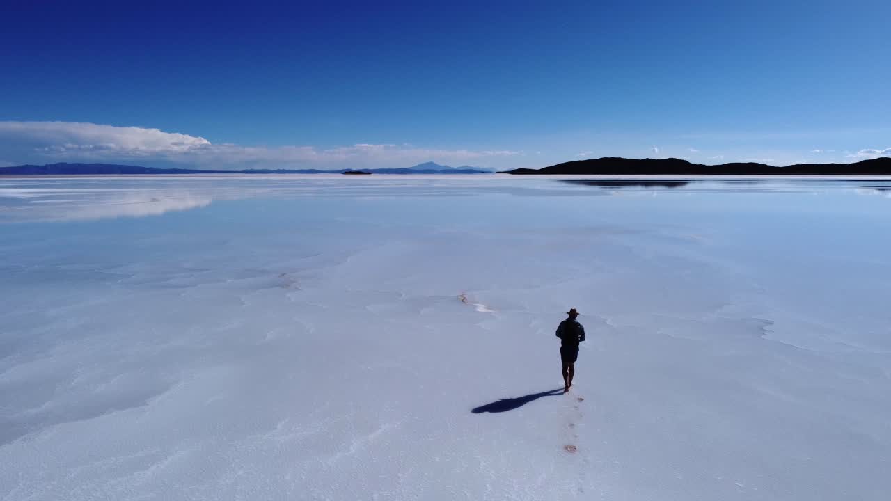 Man Casts Shadow Onto Surface Of Uyuni Salt Flat Lake, Bolivia Aerial ...