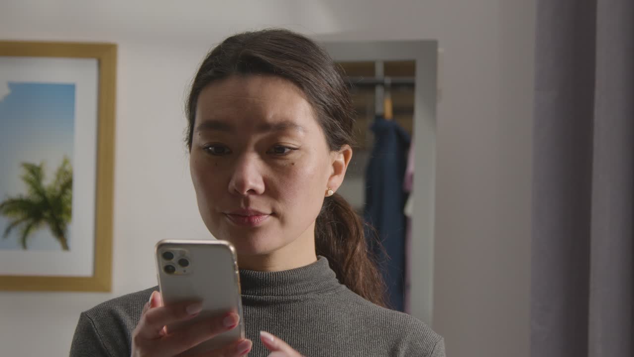 Free stock video - Pleased young woman at home receiving text message ...