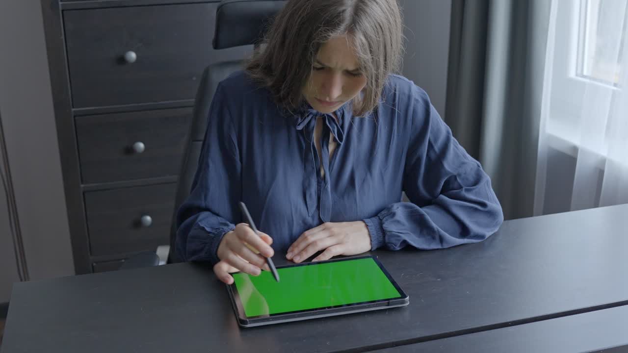 Woman Is Thinking While Pointing At Her Green Screen Tablet In Home ...