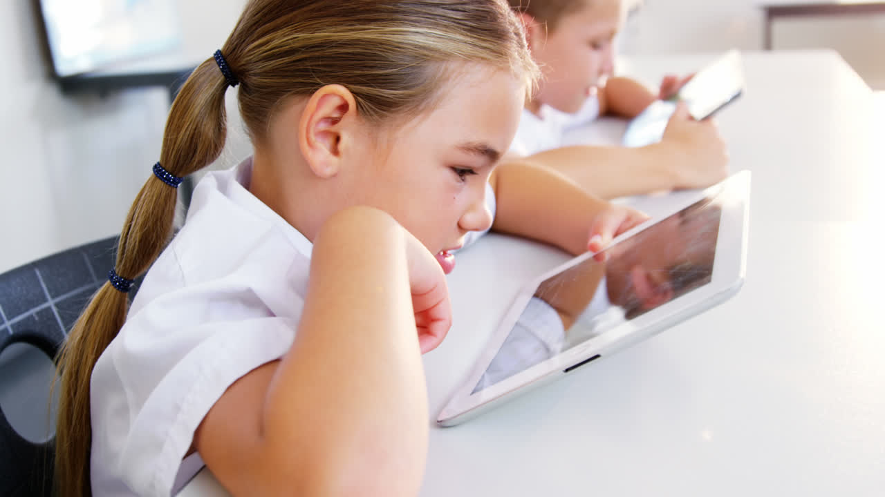 Premium stock video - School kids using digital tablet in classroom