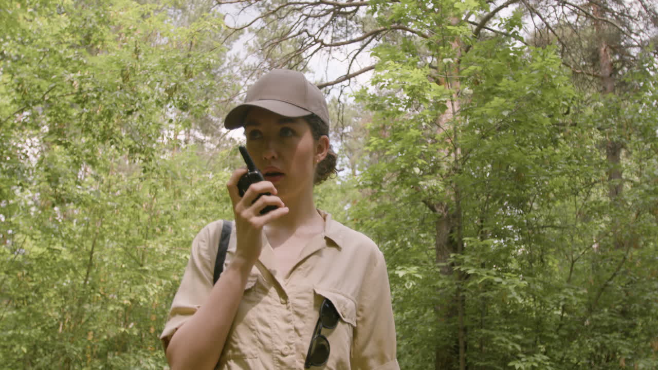 Free stock video - Lower view of caucasian female forest warden talking ...
