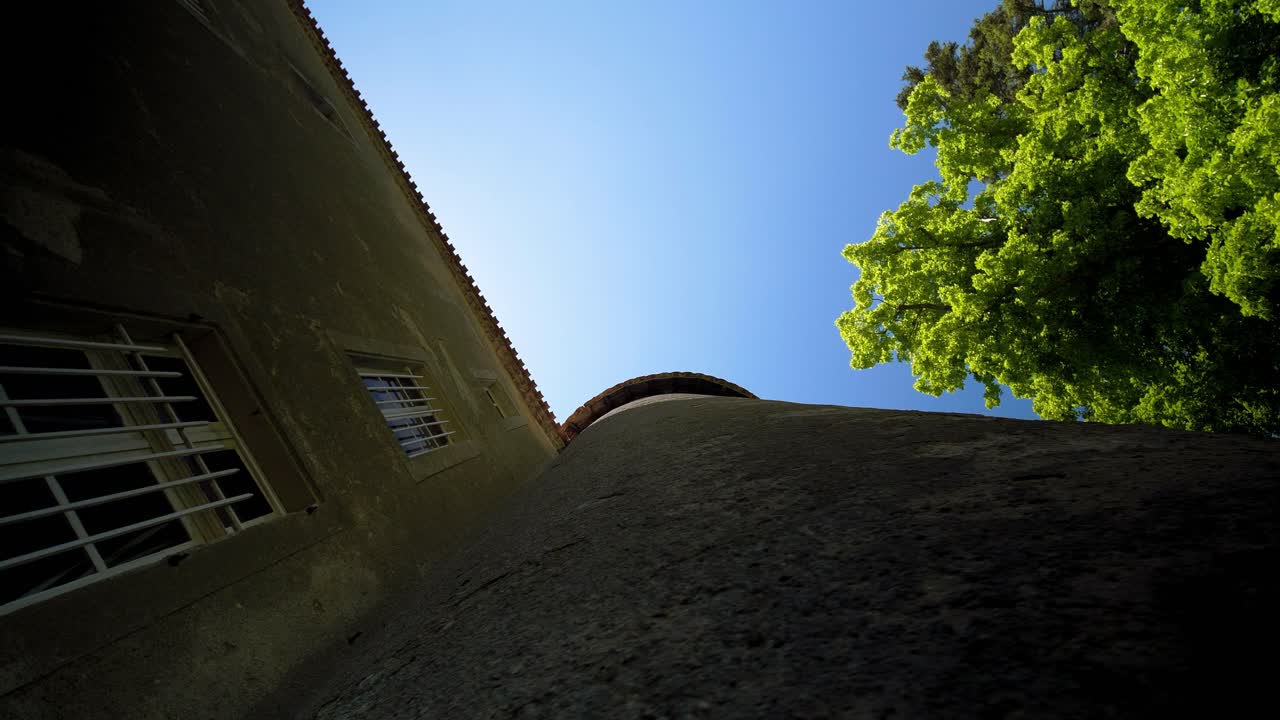 Premium stock video - Slow arcing shot around a tower wall adjoined ...