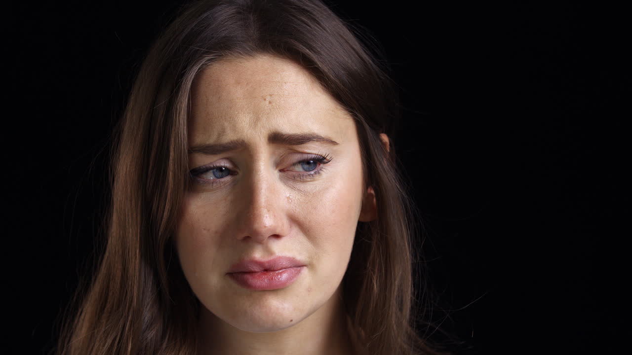 Studio Shot Of Unhappy Young Woman Crying Into Camera | Premium Stock ...