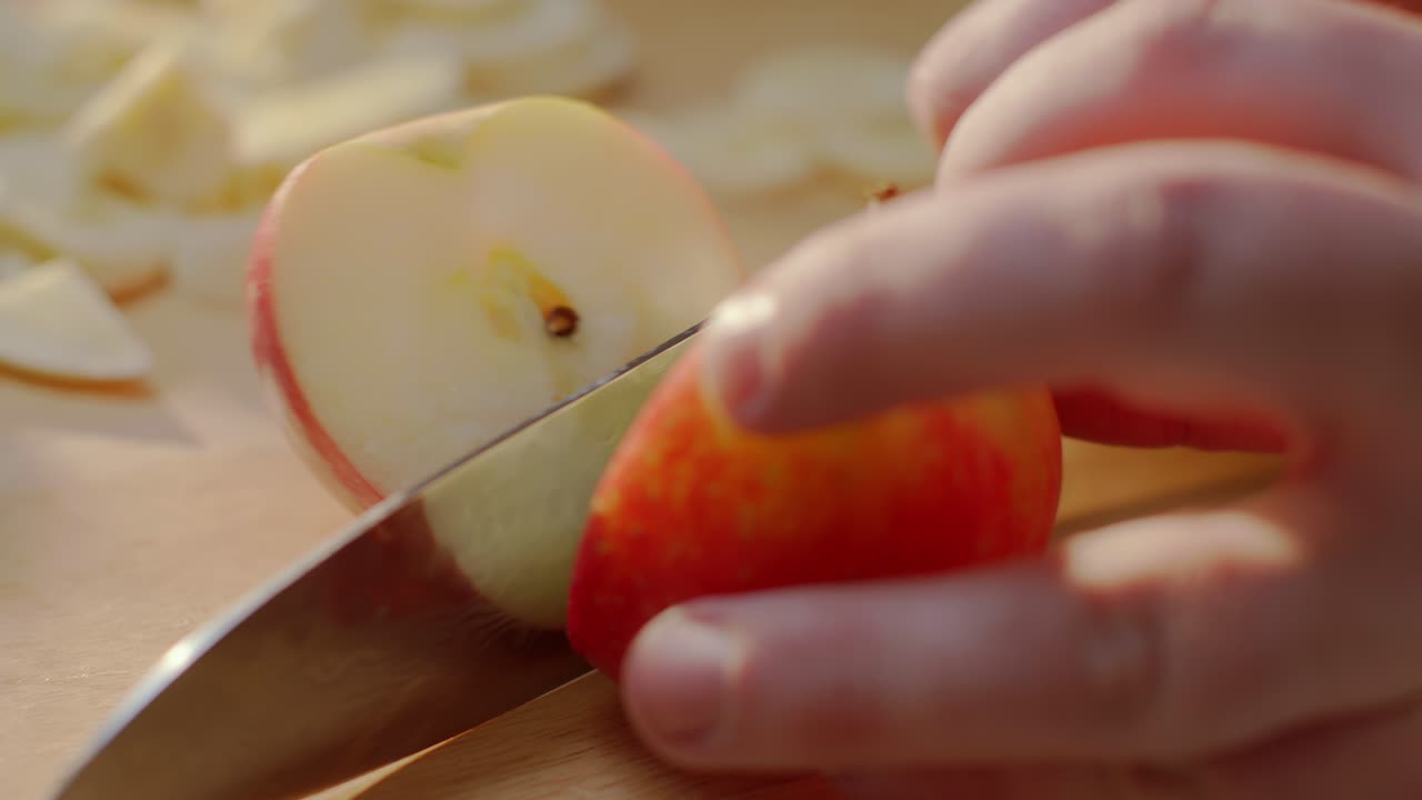 Premium stock video - Dicing an apple with a large knife on cutting board