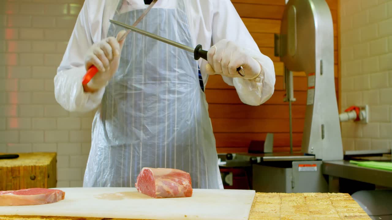 Butcher sharping knife and chopping meat 4k Premium Stock Video Footage