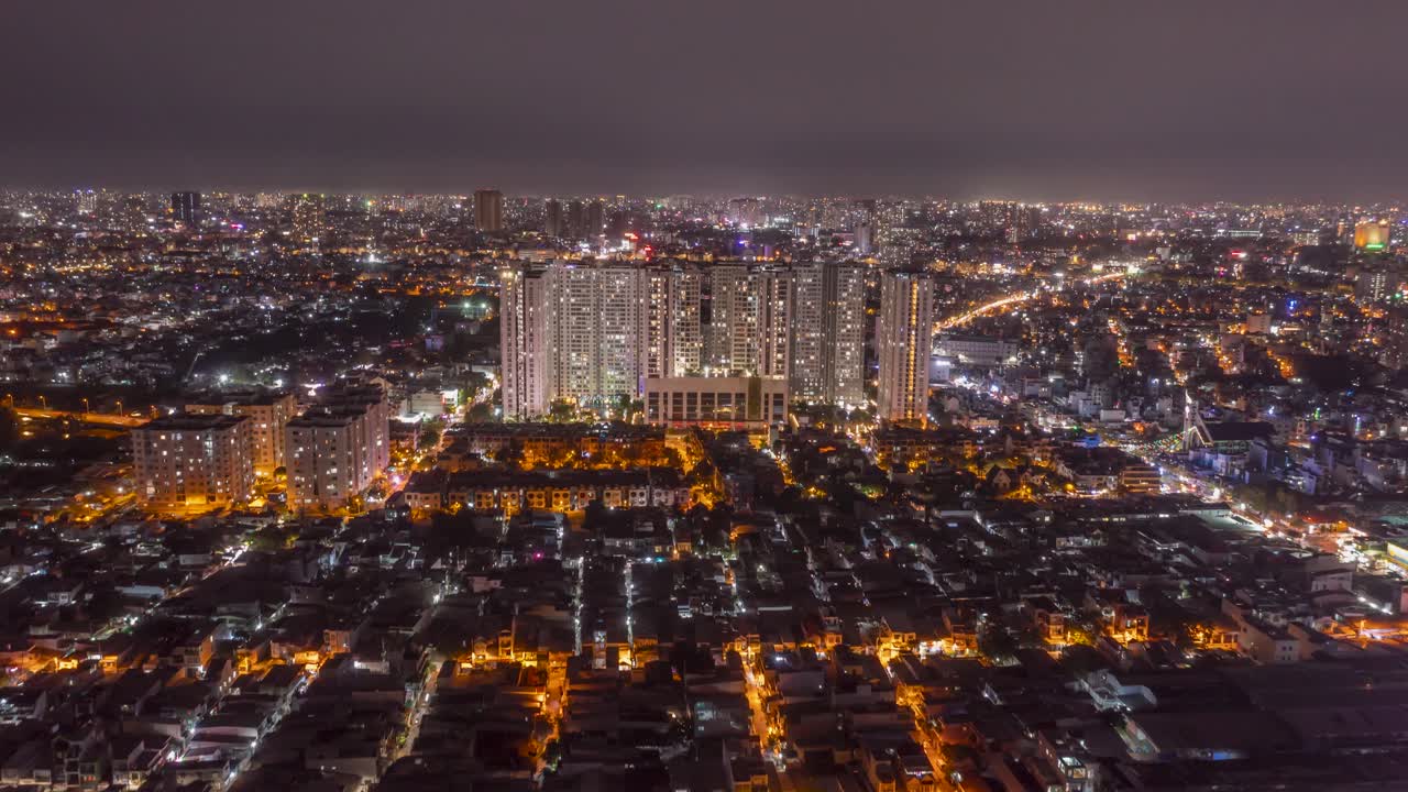 Night aerial hyperlapse in dense urban area with large residential ...