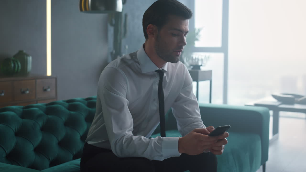Premium stock video - Serious business man browsing internet on mobile ...