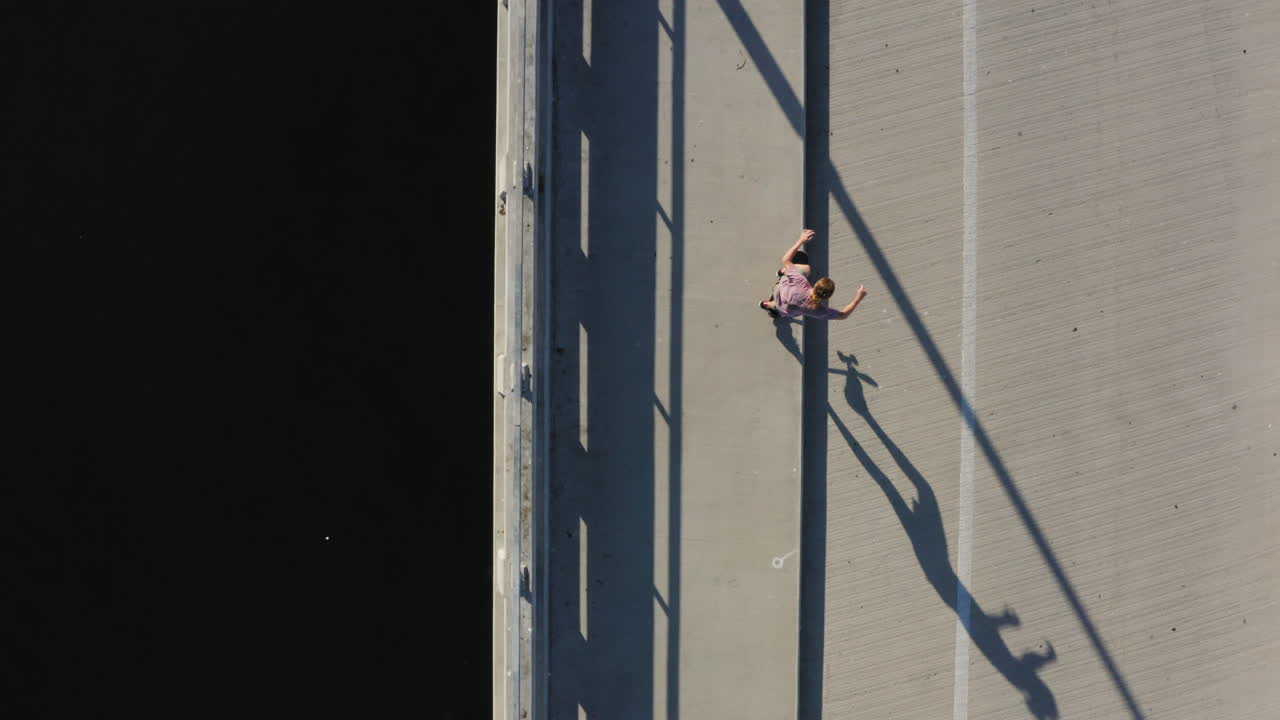 Premium stock video - Person skateboarding on coastal asphalt sideway ...