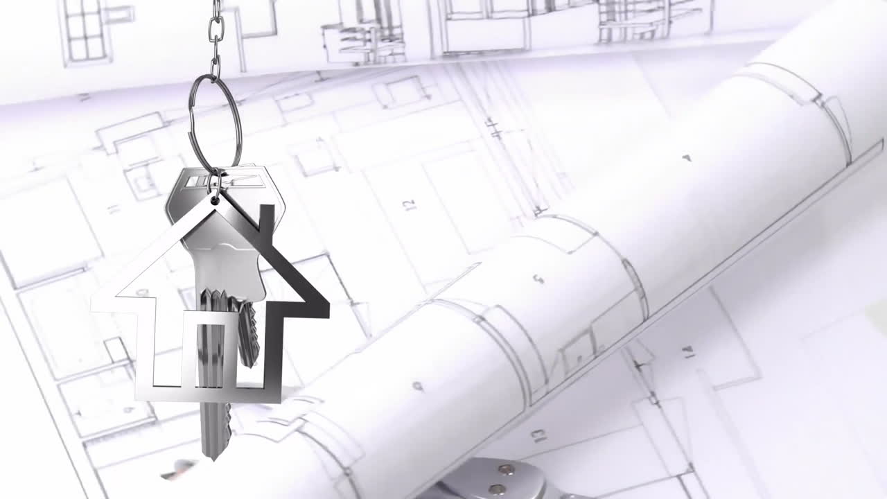 House keys and key fob hanging over architectural drawing in the ...