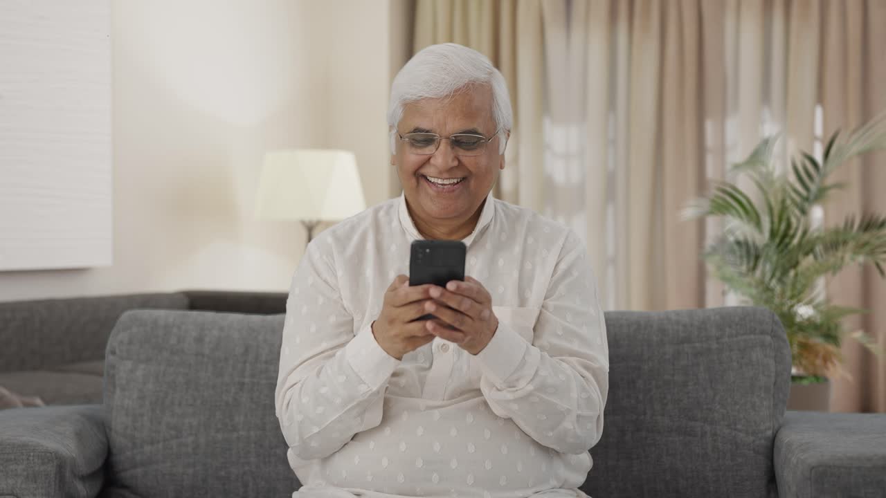 Happy indian old man chatting with someone on phone Premium Stock Video ...