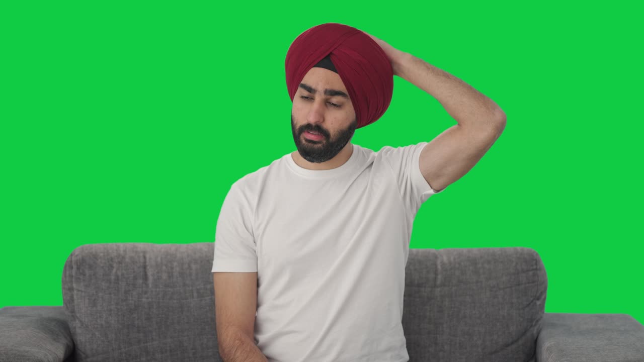 Premium stock video - Confused sikh indian man thinking green screen