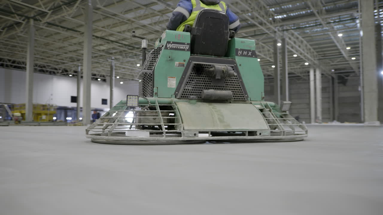 Worker Operating a Power Trowel on a Concrete Floor | Premium Stock ...