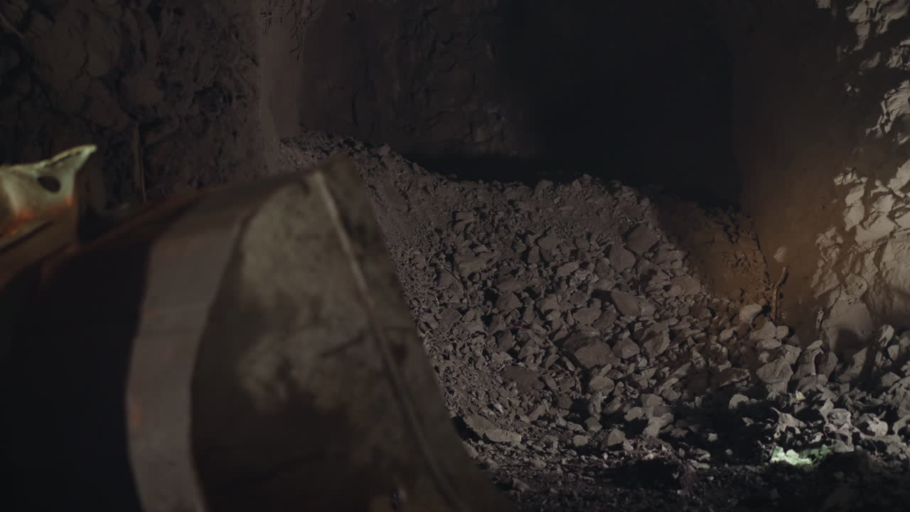 Large dipper of heavy machinery scooping up ore in mine Premium Stock ...