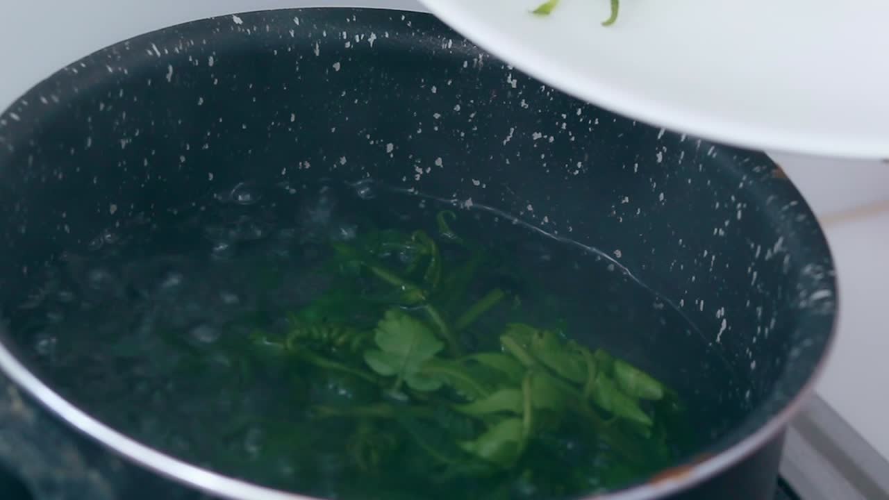 Premium stock video - Adding wild edible fiddlehead ferns or diplazium ...