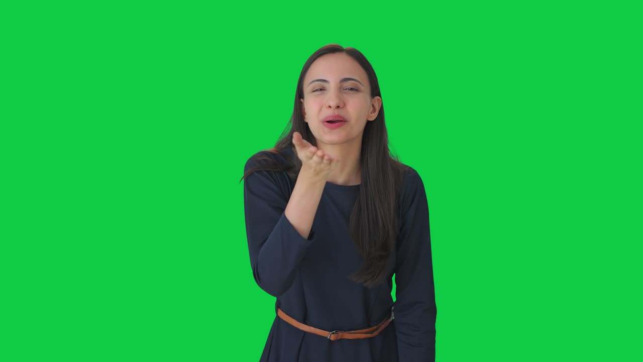 Premium stock video - Happy indian girl giving flying kisses green screen