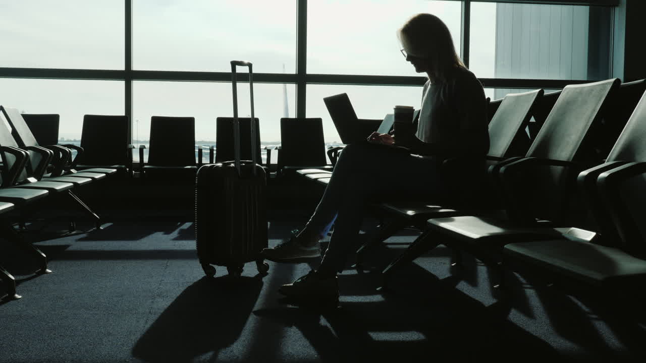 Premium stock video - Business woman working while waiting for flight