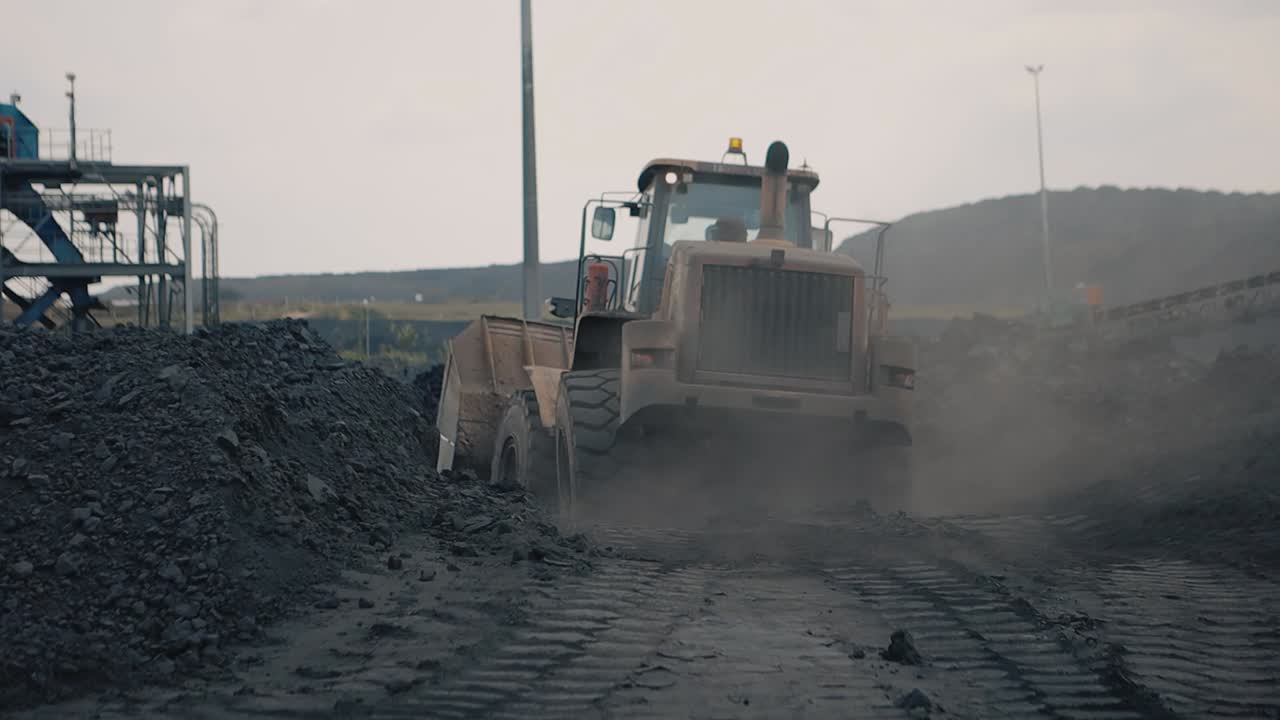 In The Stark Backdrop Of The Mine, A Front End Loader Casts A ...