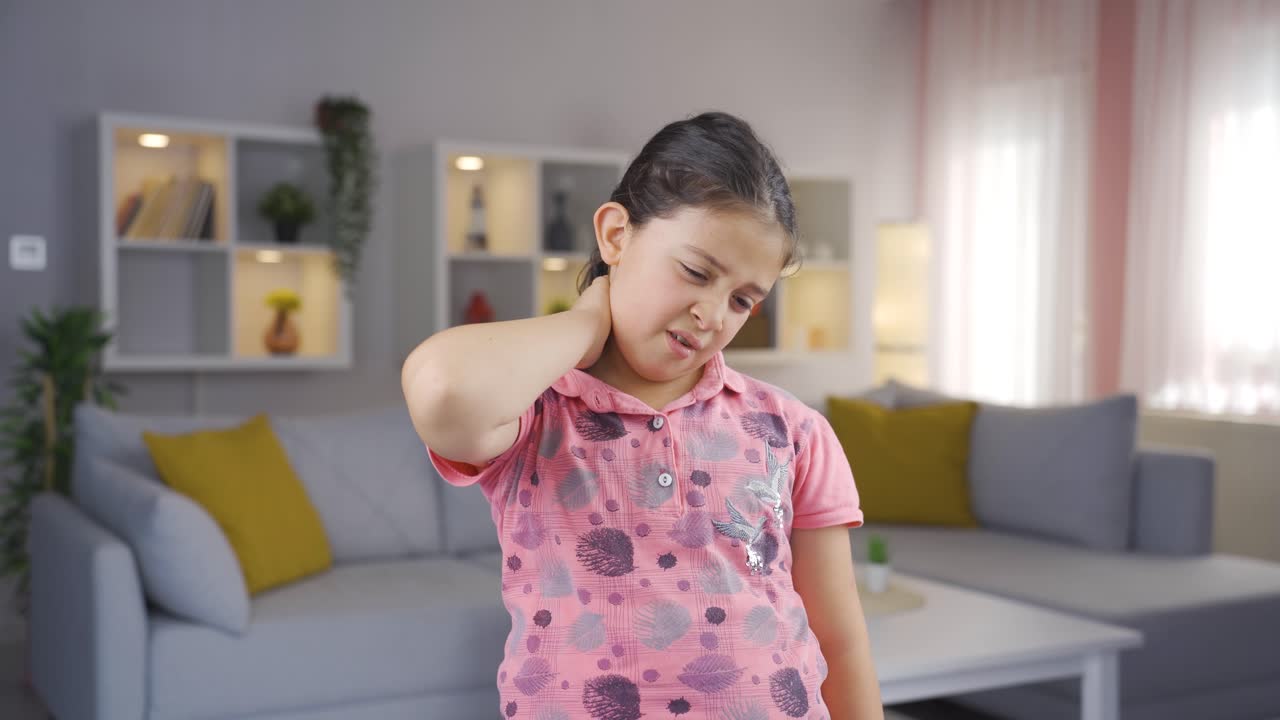 Girl child with neck pain. | Premium Stock Video Footage