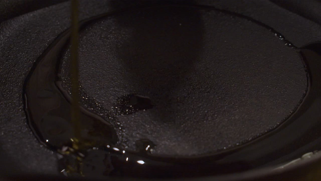 Cooking oil falling on bottom of black frying pan Premium Stock Video ...