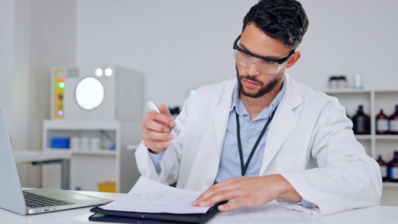 Scientist writing a science report to document new | Premium Stock ...