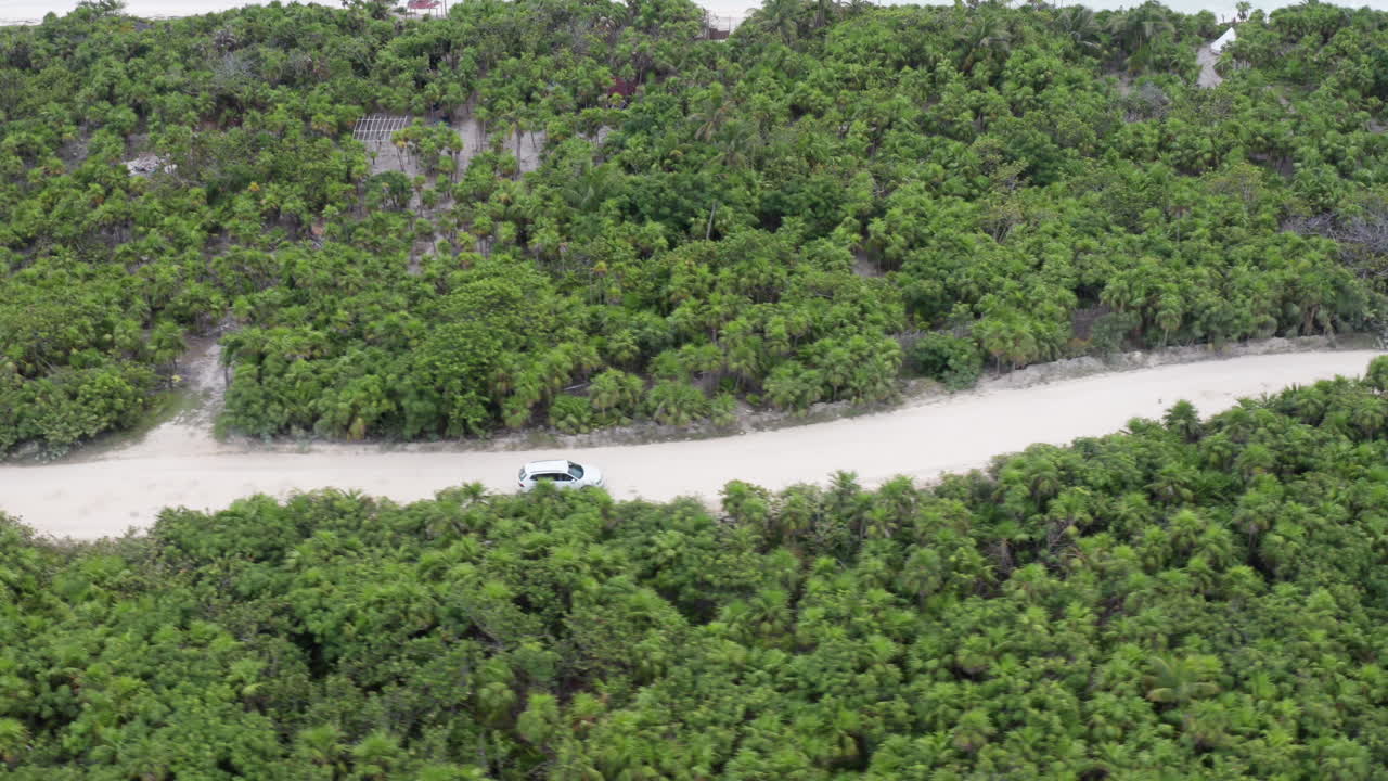 SUV Driving On A Peninsula Traveling Through Green Tulum Mexico ...