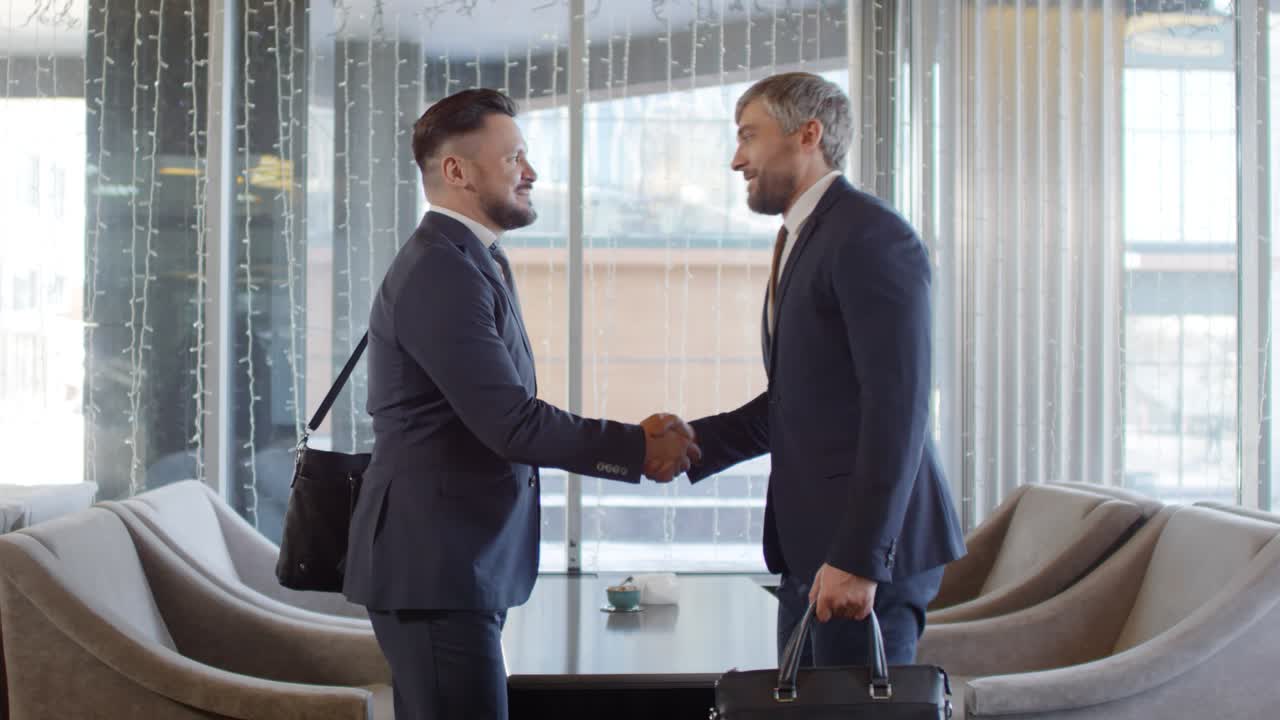 Two Businessmen Greeting Each Other in Café | Premium Stock Video Footage