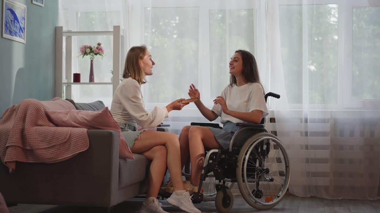 Premium stock video - Blonde woman gives book to disabled partner to ...