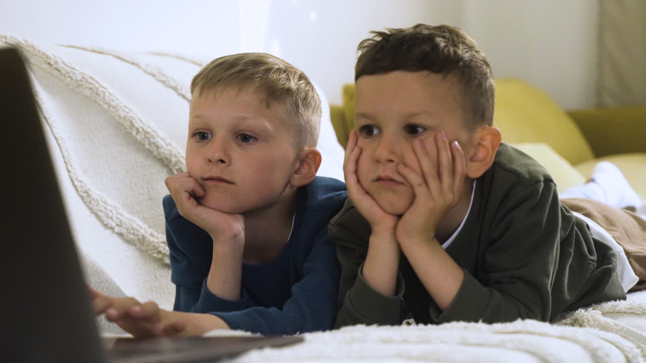 Free stock video - Kids enjoying film on the sofa