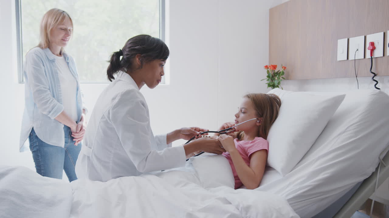 Premium stock video - Female doctor letting girl patient listen to her ...