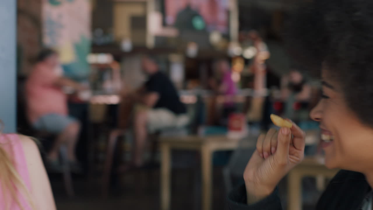 Funny woman catching food in mouth best friends in restaurant playing ...