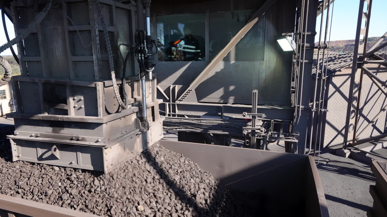 Mine operator oversees ore pouring into rail wagon at Rapid Loading ...