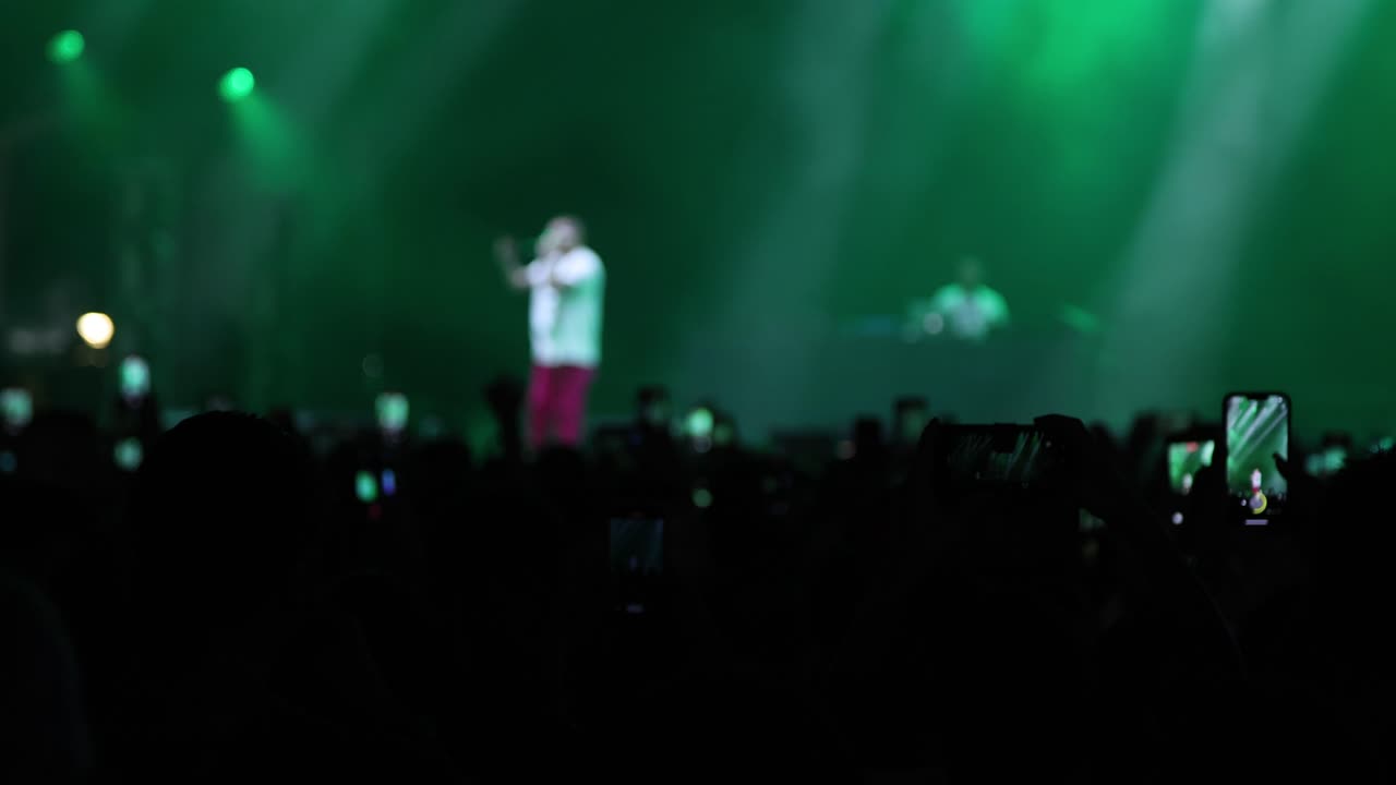Singer And His Band Performing On Bright Scene In Front Of Fans Crowd ...