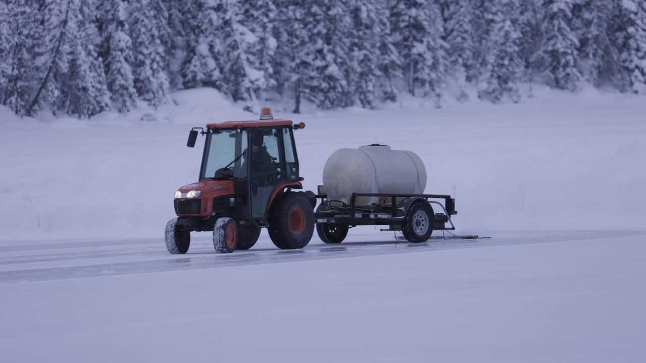 Premium stock video - Ice resurfacer making ice rink on lake louise