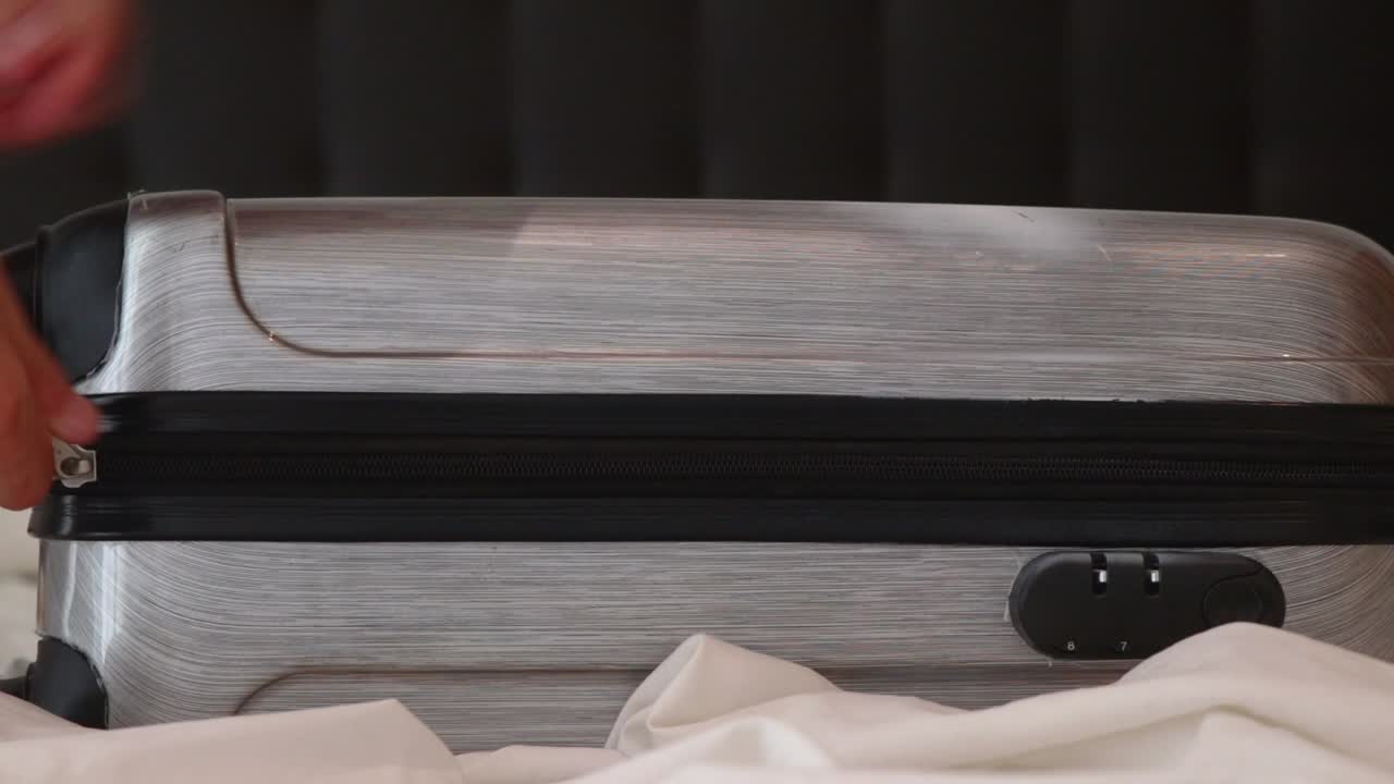 Premium stock video - Unpacking a suitcase