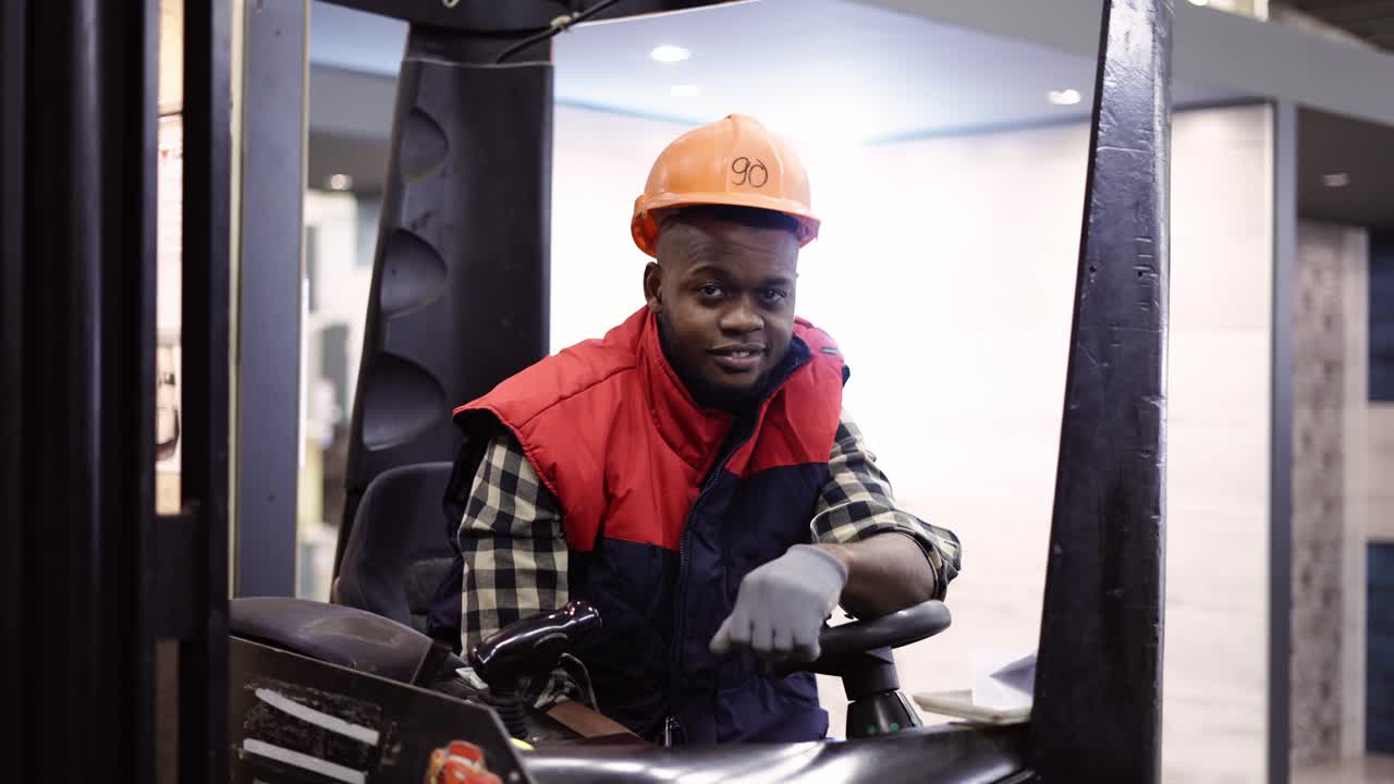 Premium stock video - Portrait of forklift operator in the warehouse ...