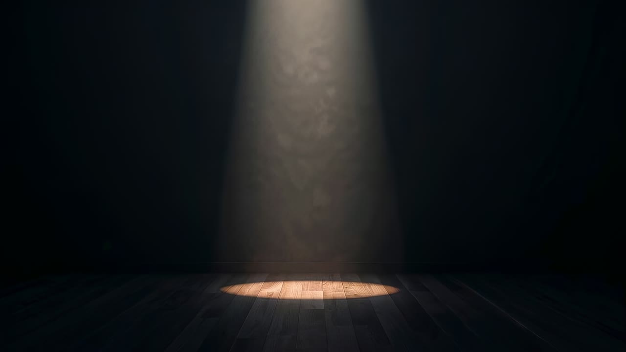 Appearing overhead spotlight casting warm circle on wood floor ...