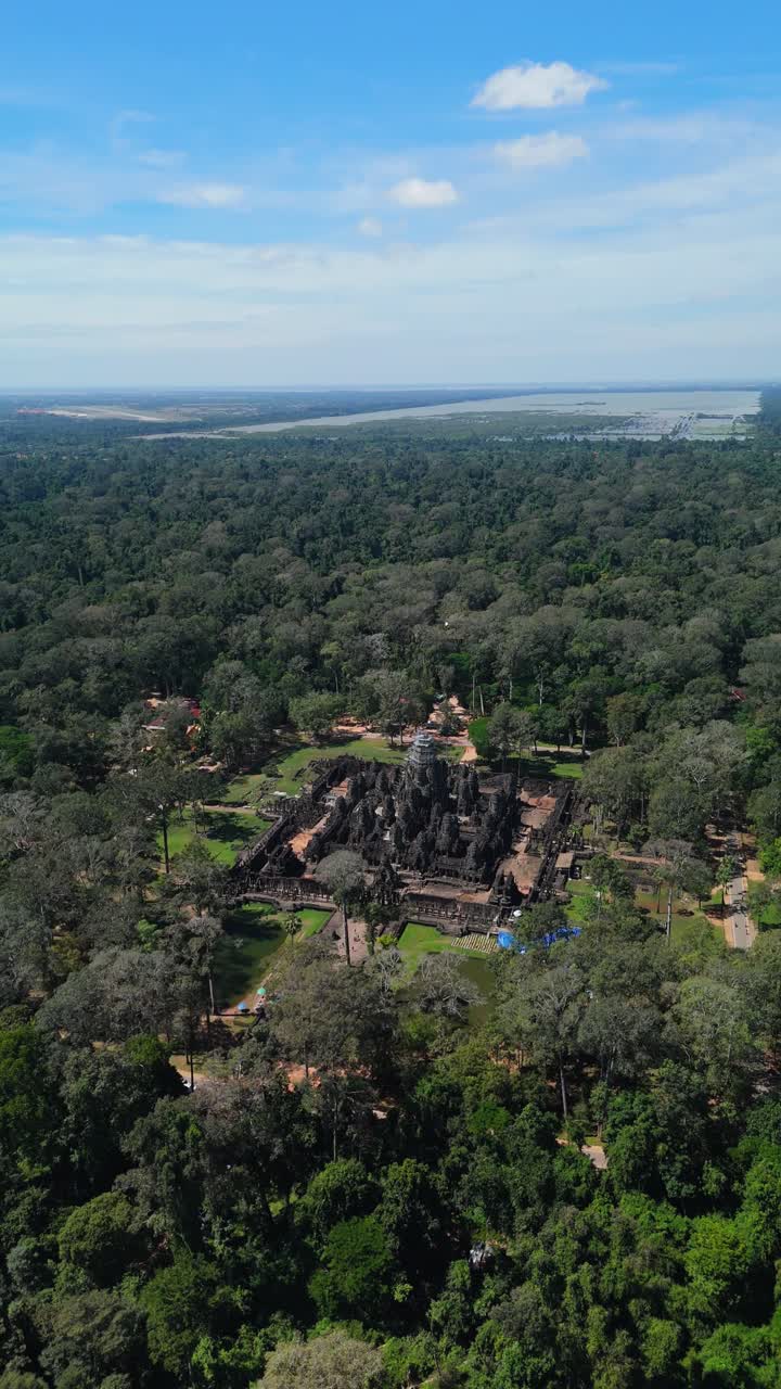 Aerial approach orbiting right toward Bayon Temple, revealing ...