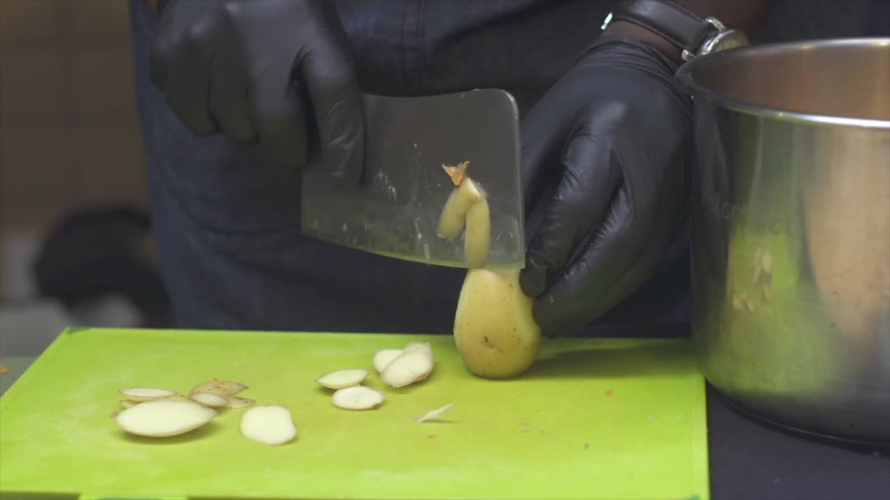 Potato spud skin peeled by hand using butchers cleaver on green ...
